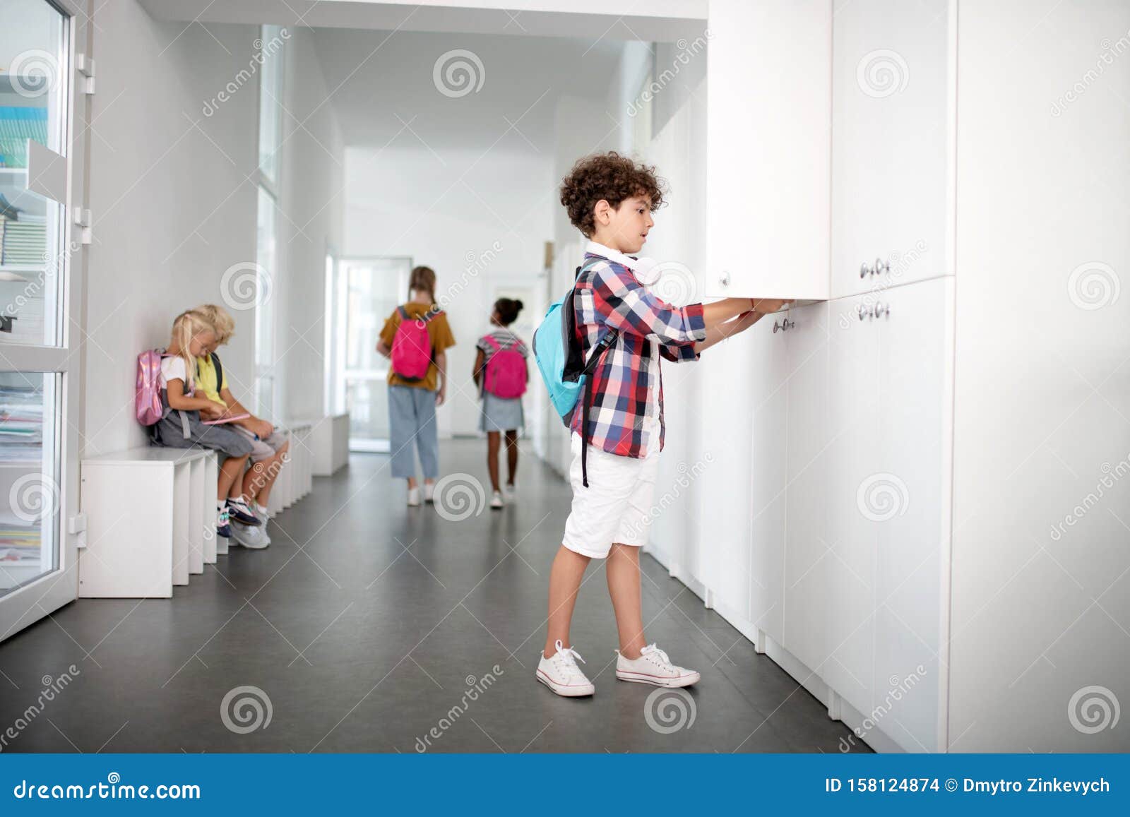 Schoolboy Wearing Backpack Putting Things Inside Locker Stock Photo ...