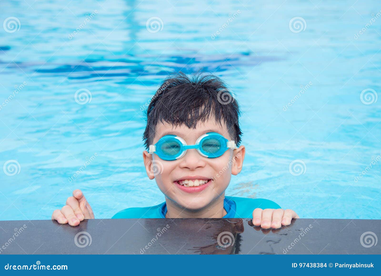 Boy Wearing Blue Goggles and Smiling in Pool Stock Photo - Image of ...