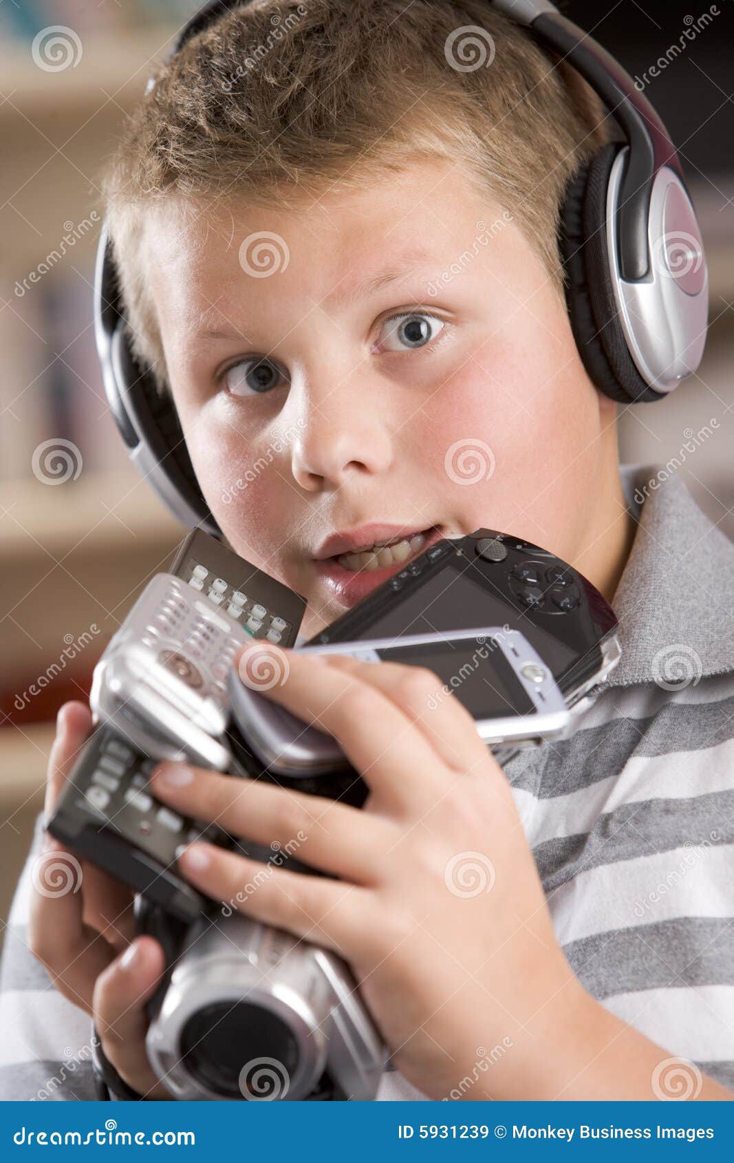 Boy Wearing Headphones Holding Many Electronics Stock Image - Image of ...