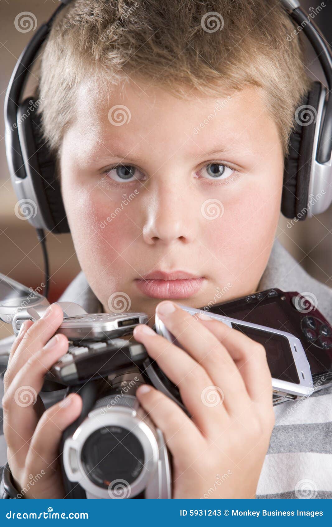 Boy Wearing Headphones Holding Many Electronics Stock Image - Image of ...
