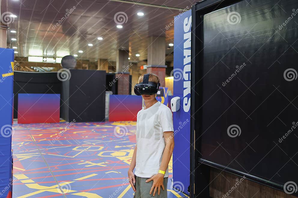 Boy Wearing a Virtual Reality Visor Inside a Play Space Set Up for the ...