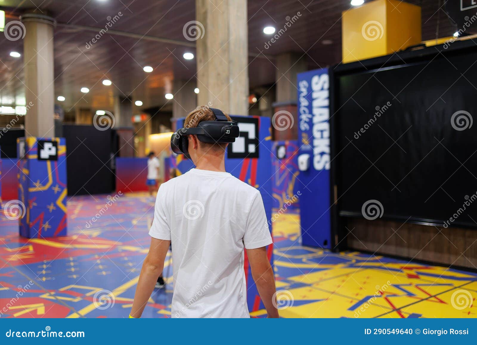 Boy Wearing a Virtual Reality Visor Inside a Play Space Set Up for the ...