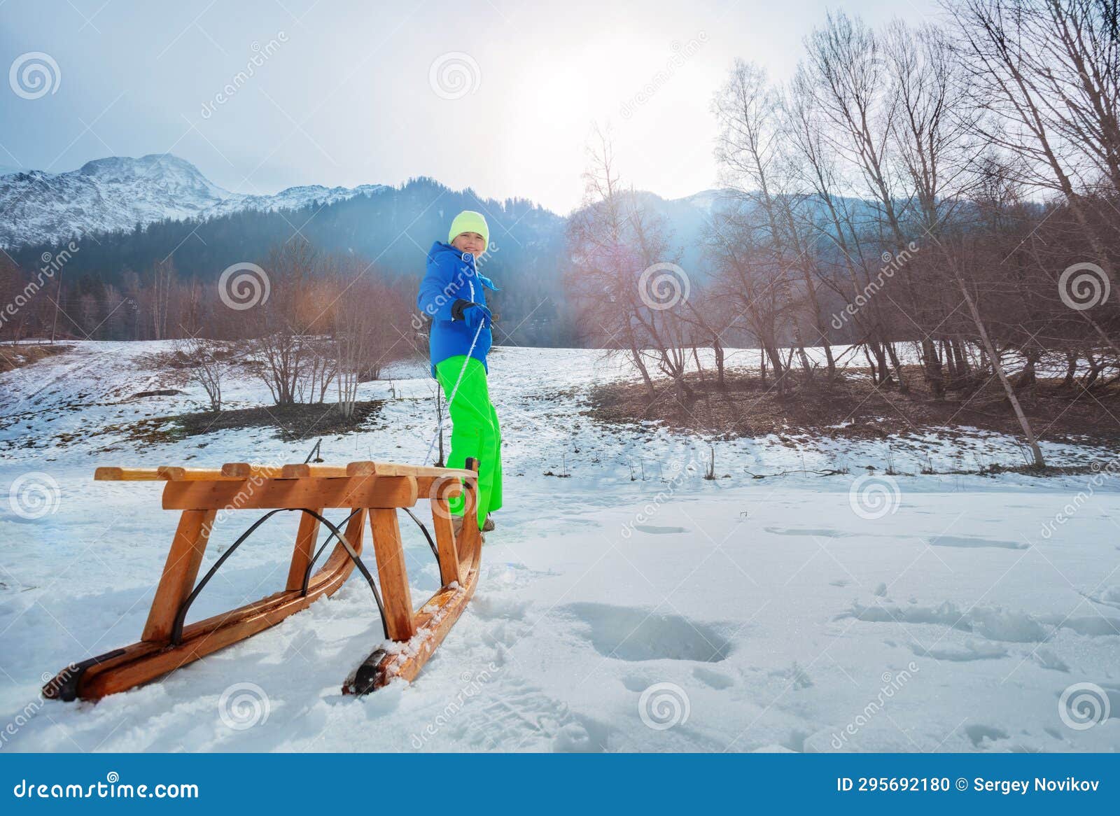 Boy in Winter Outfit Pull Wooden Sledge Uphill Turning Back Stock Photo ...