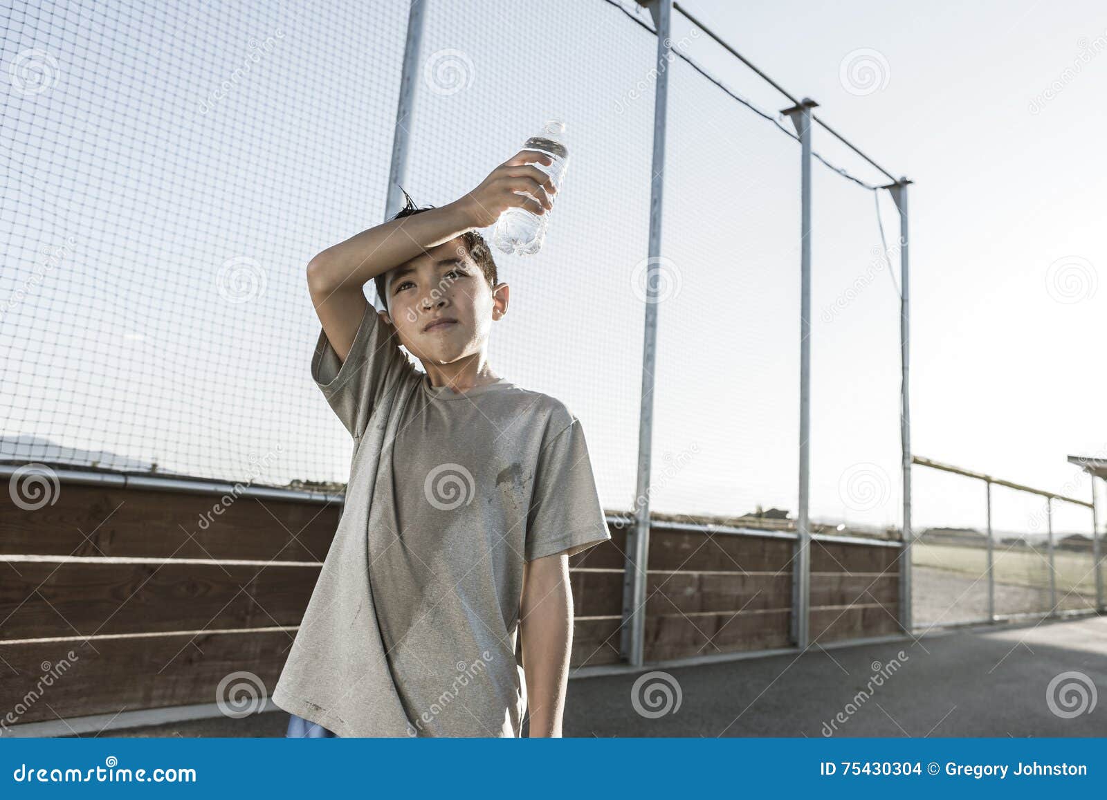 Boy wipes sweaty forehead. stock photo. Image of training - 75430304