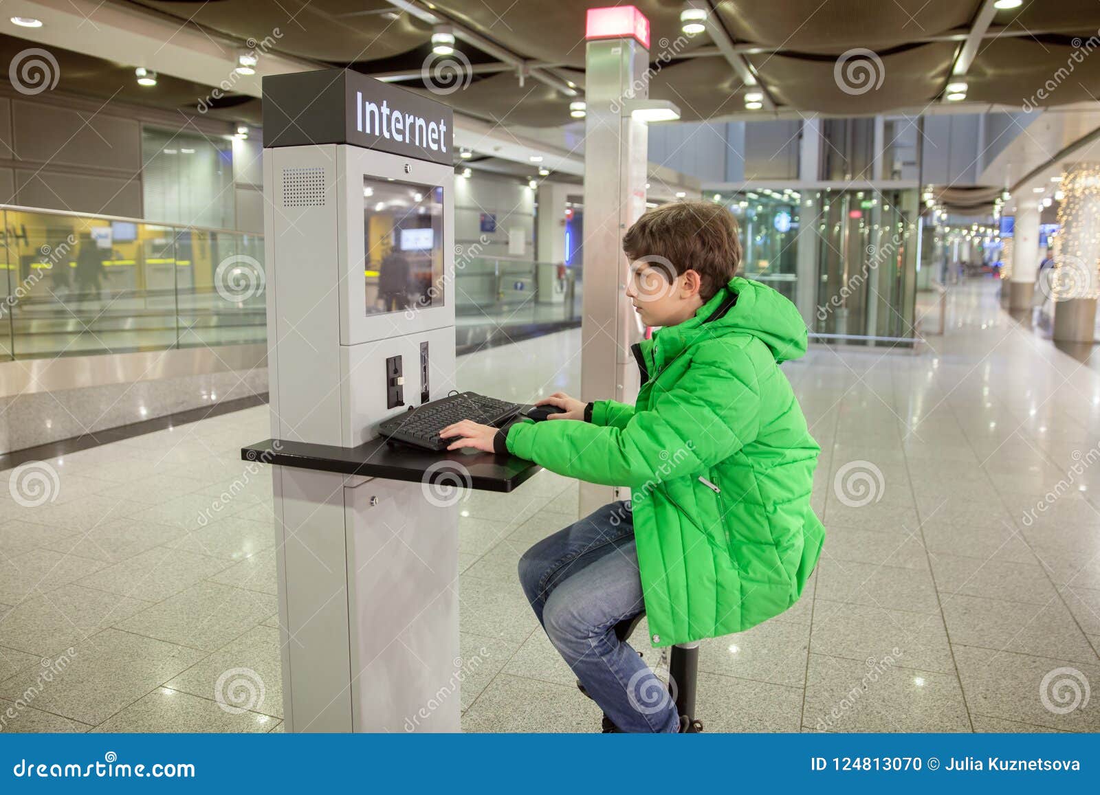 A Boy is Working at Computer in Airport Stock Photo - Image of flight ...