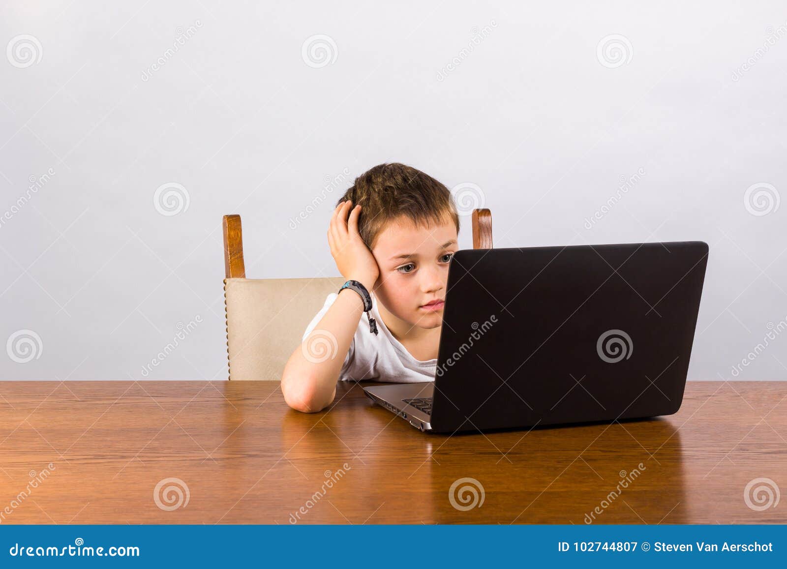 Boy working on laptop stock image. Image of homework - 102744807