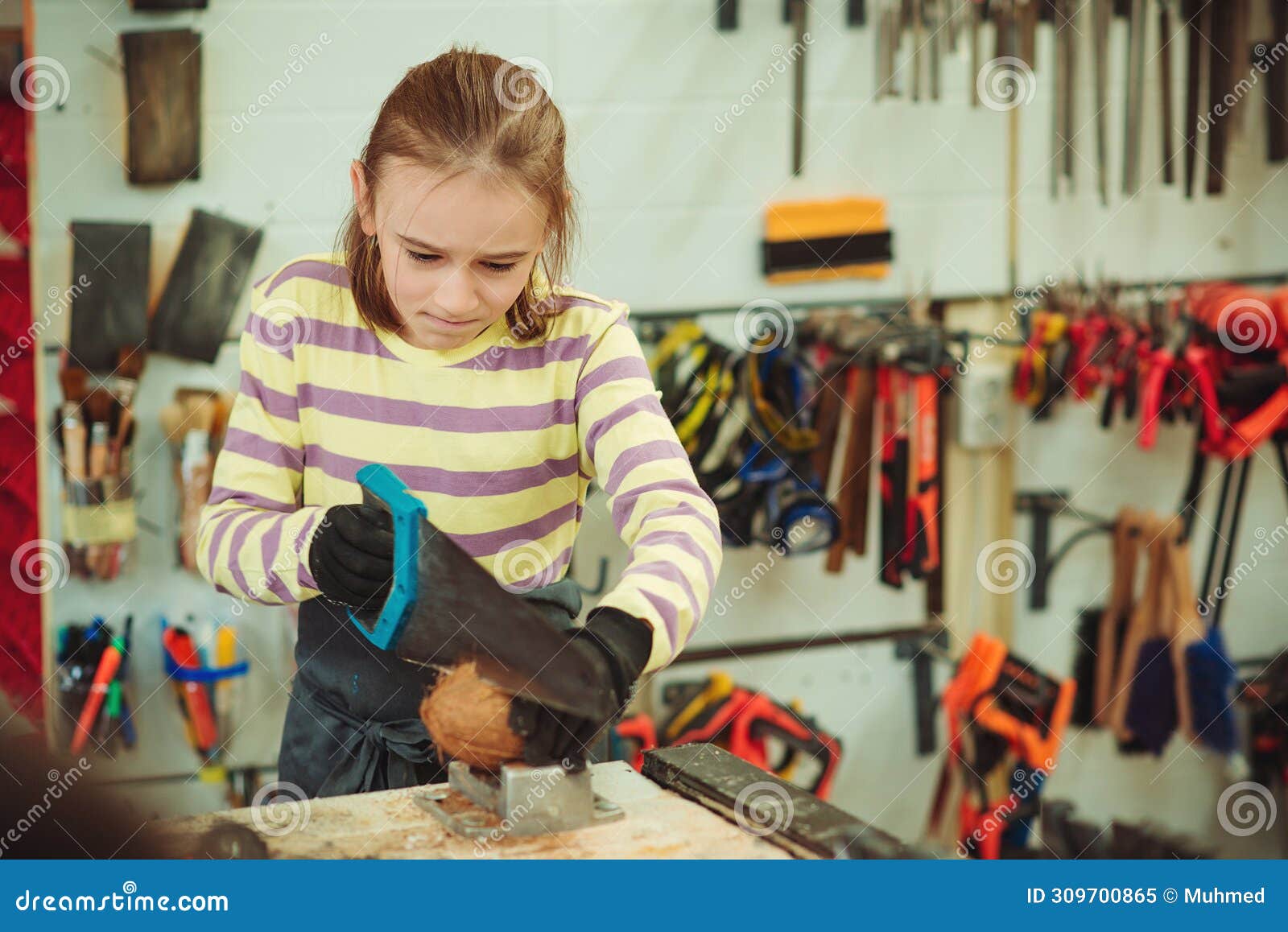 Boy in the Workshop Makes Crafts with Coconut. Young Carpenter Working ...