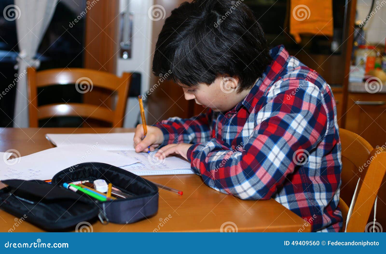 BOY writes on his notebook stock photo. Image of adolescence - 49409560