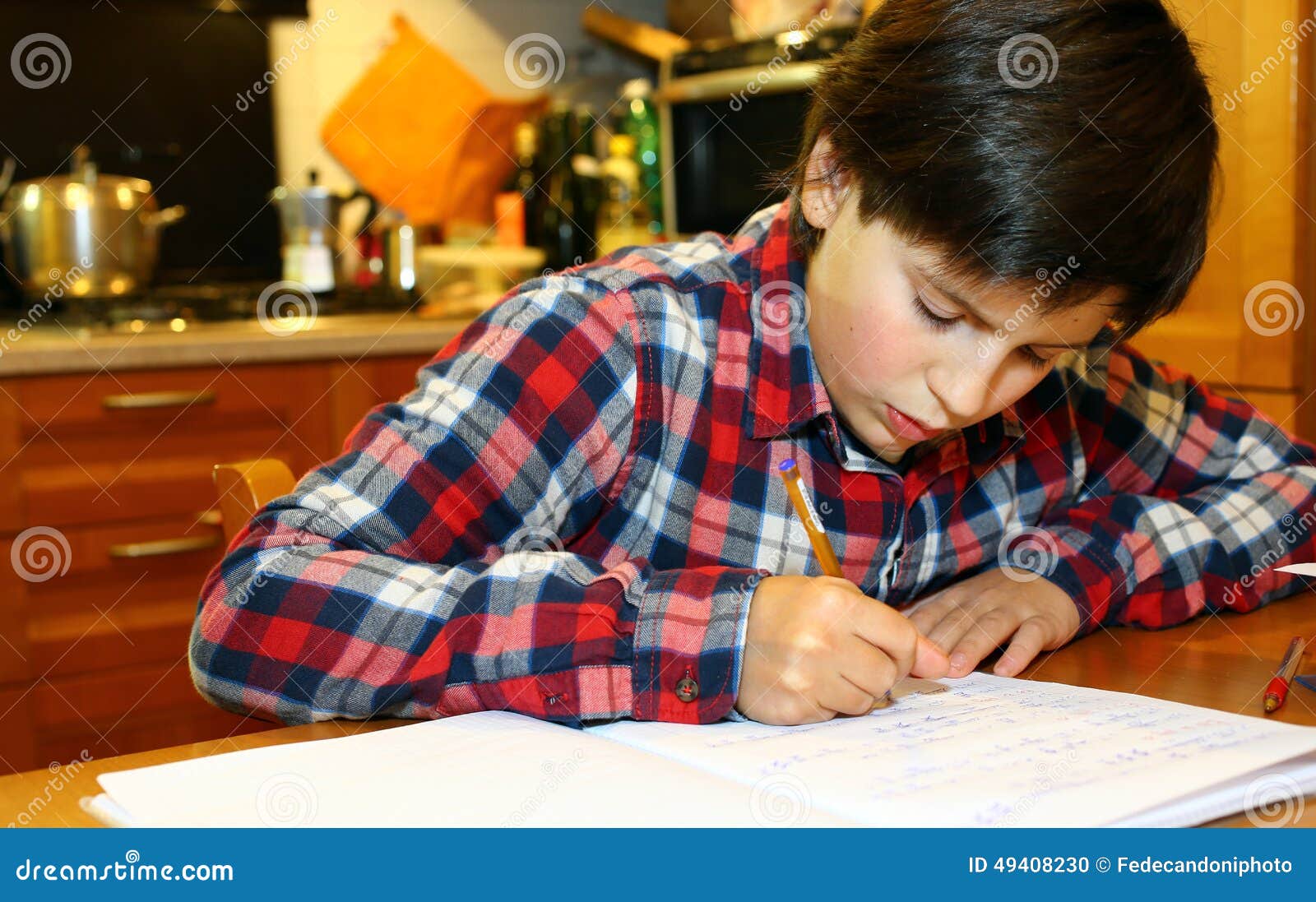 Boy writes on his notebook stock photo. Image of learn - 49408230