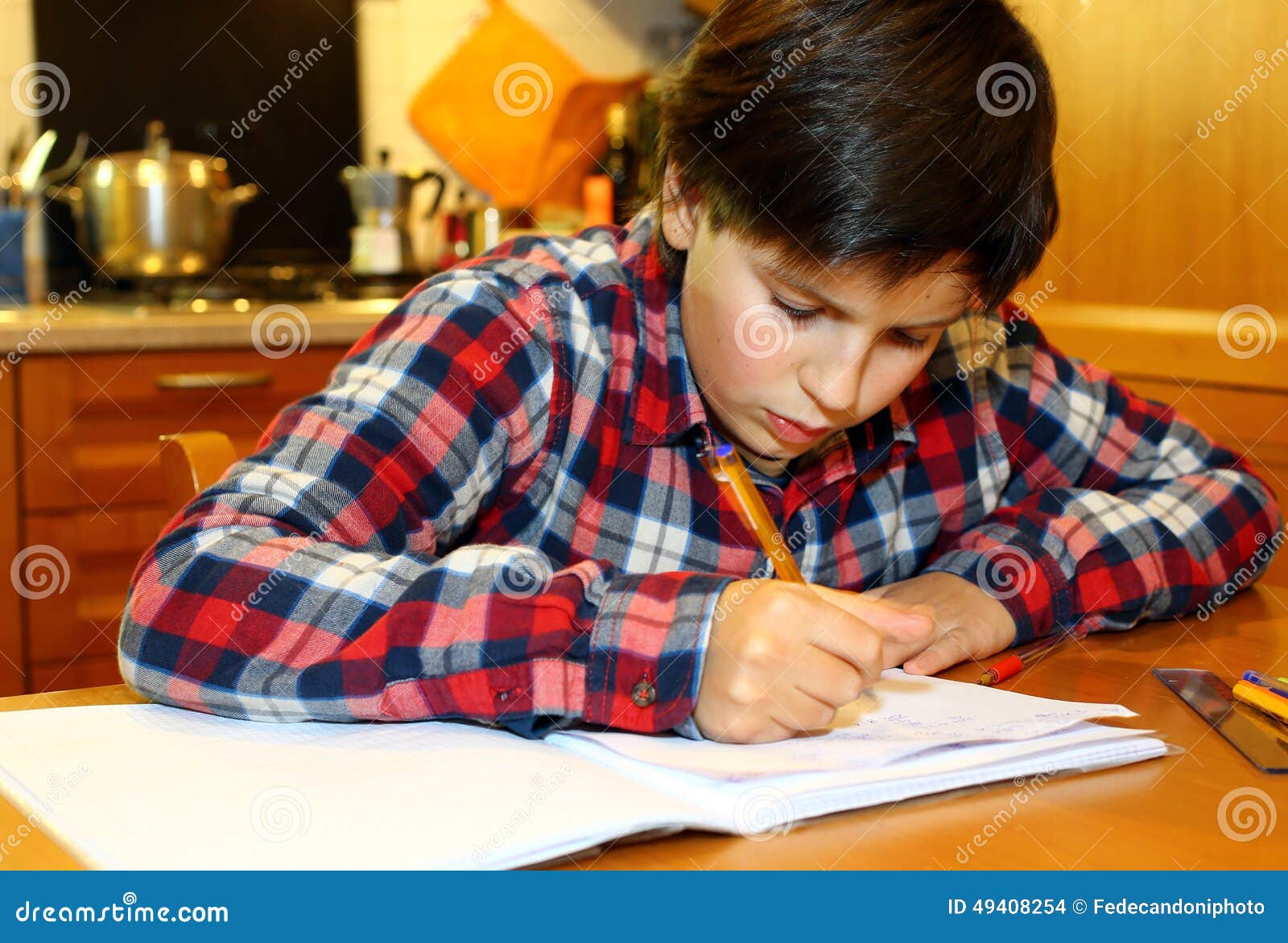 Boy writes on his notebook stock photo. Image of schoolboy - 49408254