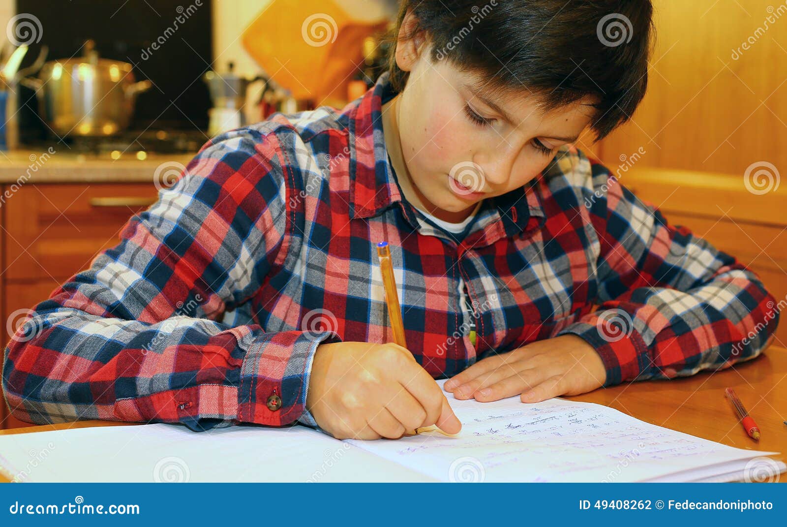 Boy writes on his notebook stock photo. Image of educations - 49408262