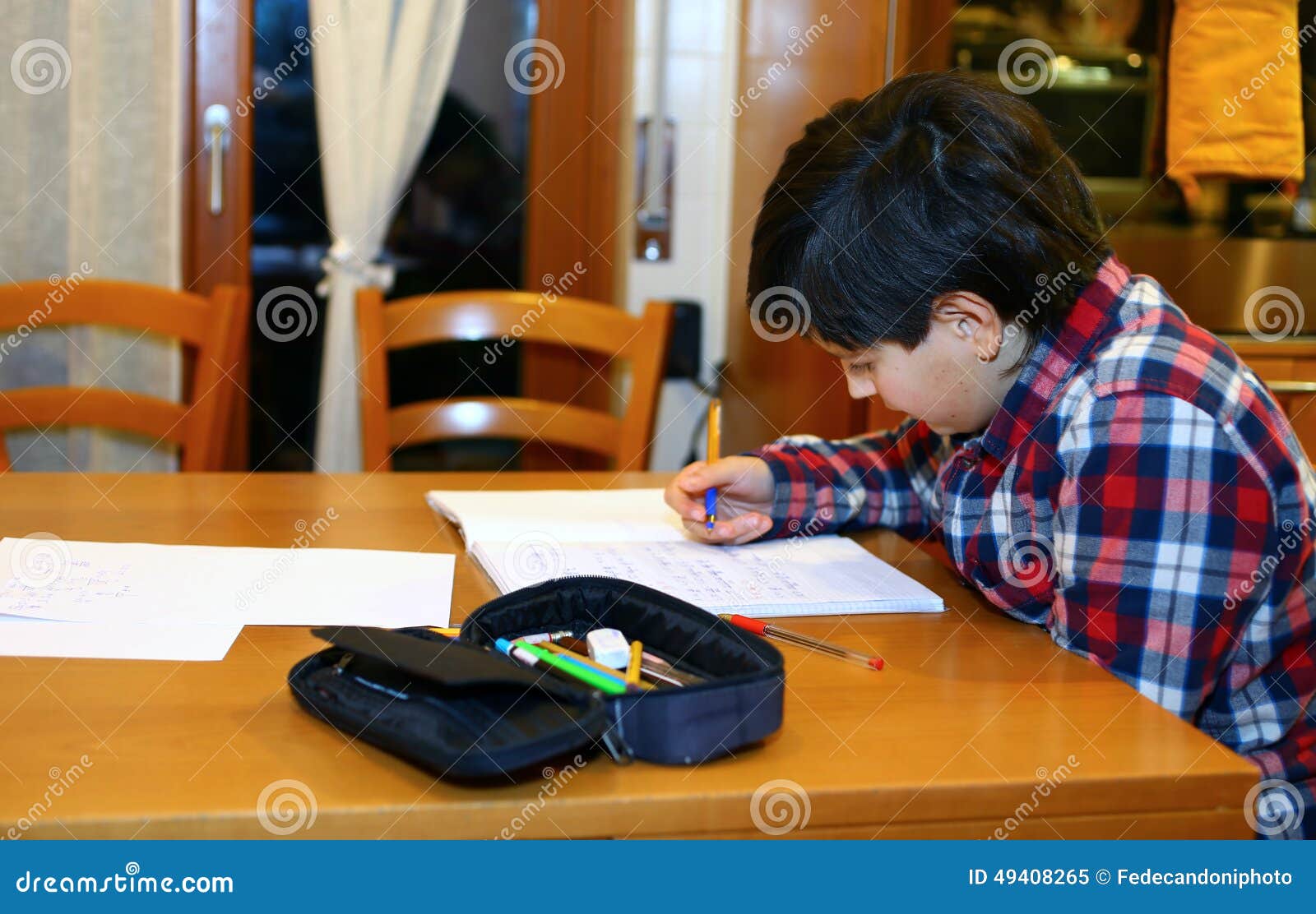 Boy writes on his notebook stock image. Image of exercises - 49408265