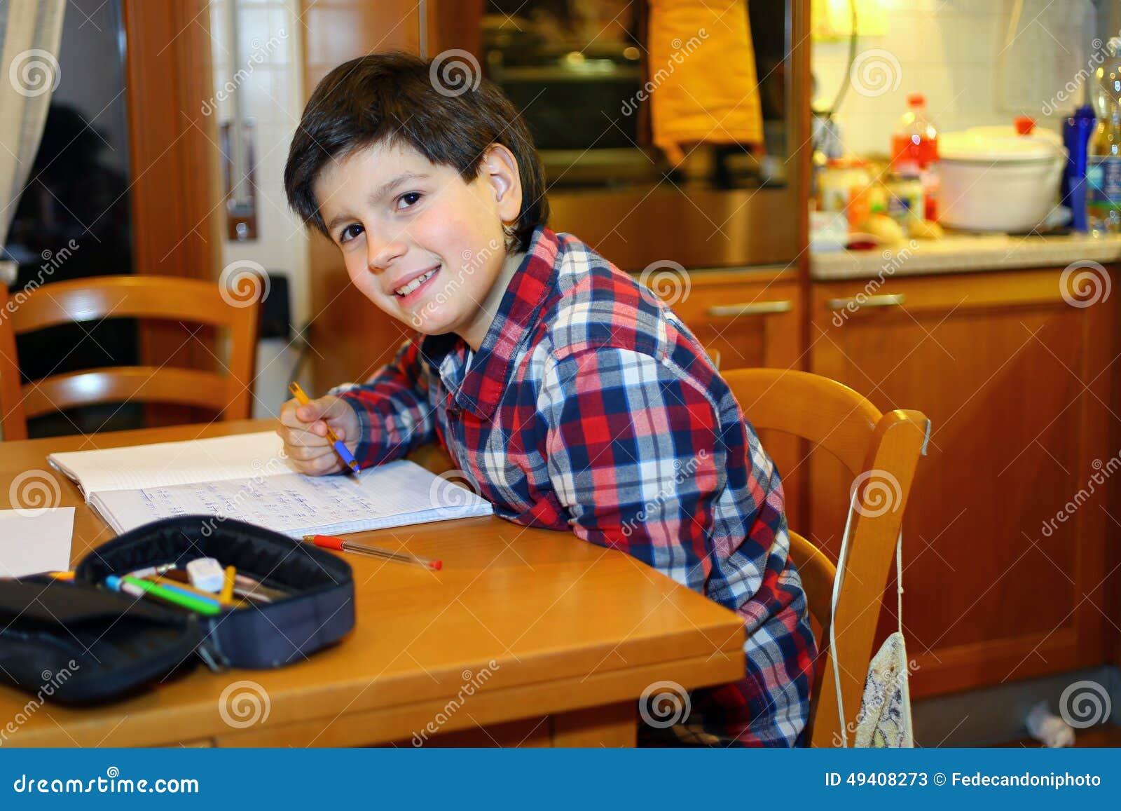 Boy writes on his notebook stock image. Image of activity - 49408273