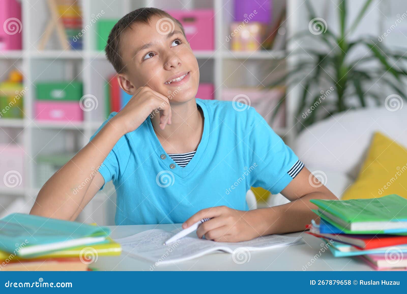 Boy Writes Lessons in a Notebook at the Table Stock Photo - Image of ...