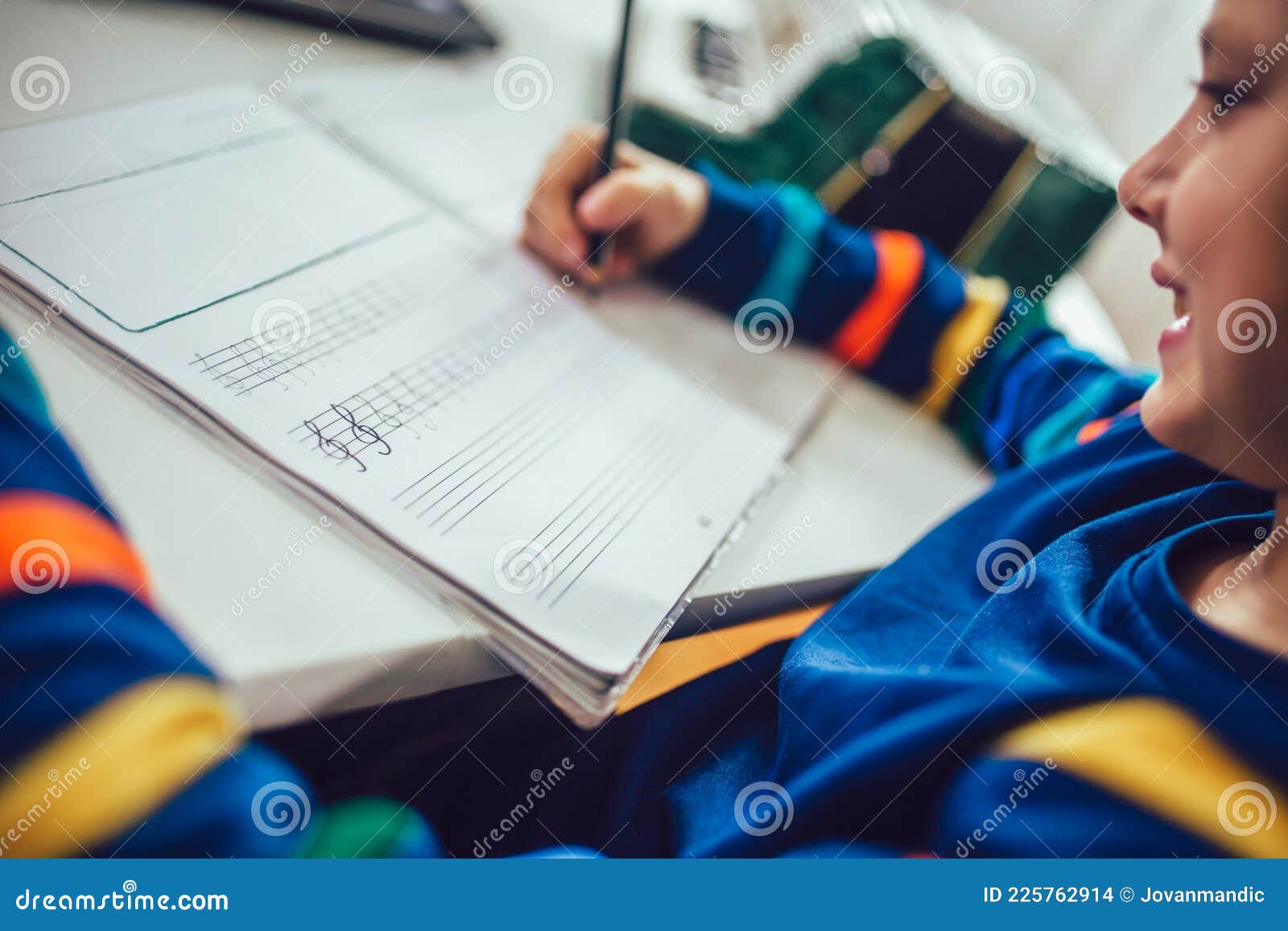 Boy Writes Musical Notes And Violin Key At Home Online Course On Laptop ...