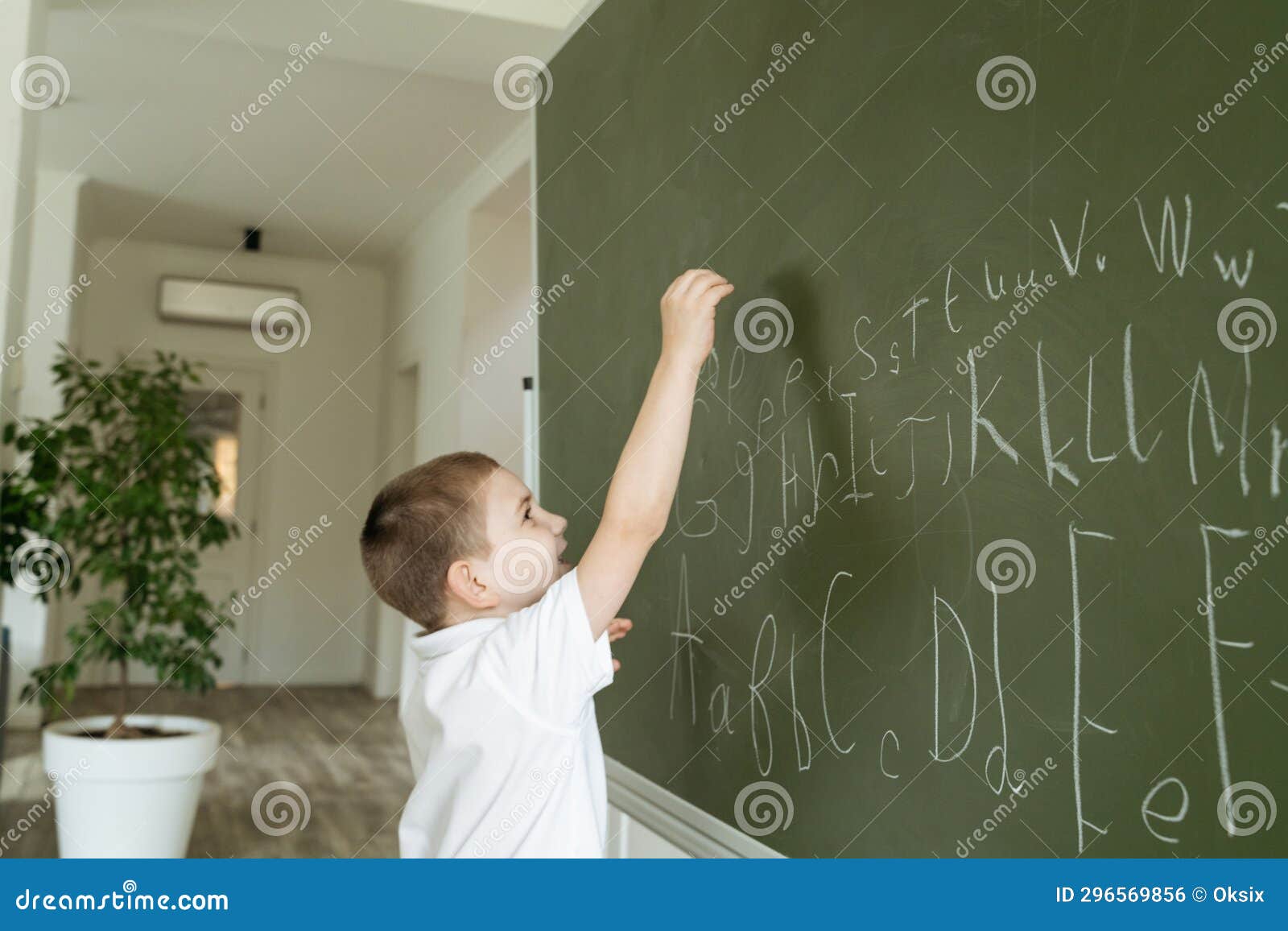 Boy Writing Abc Letters on the Green Chalkboard Stock Photo - Image of ...