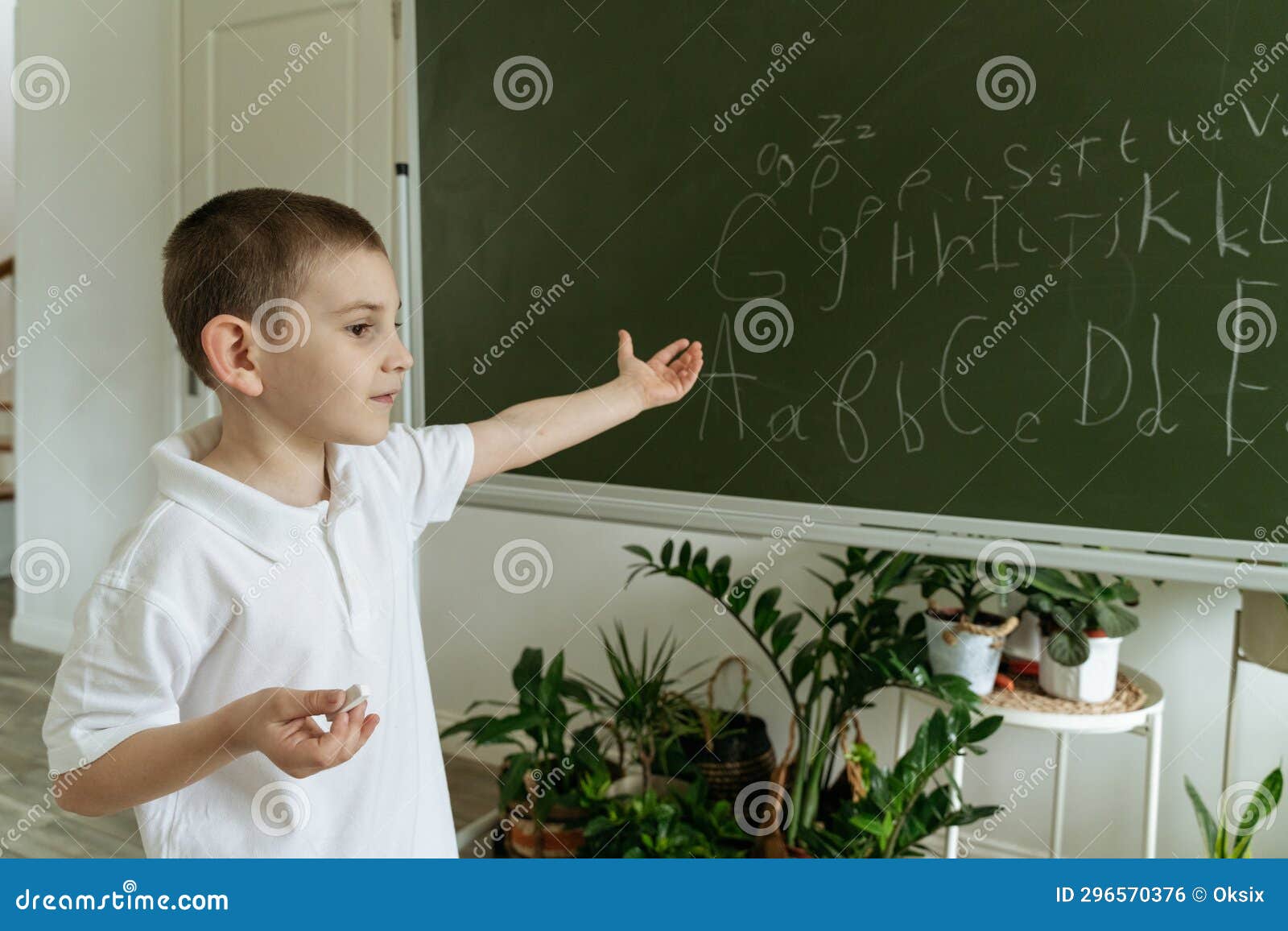 Boy Writing Abc Letters on the Green Chalkboard Stock Photo - Image of ...