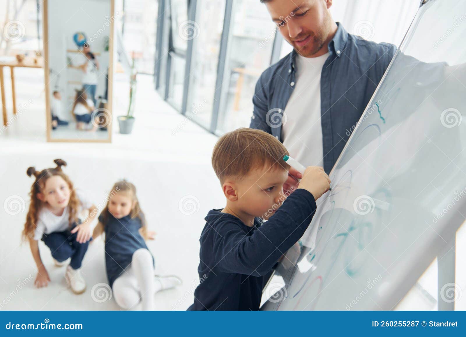 Boy Writing on the Board. Group of Children Students in Class at School ...