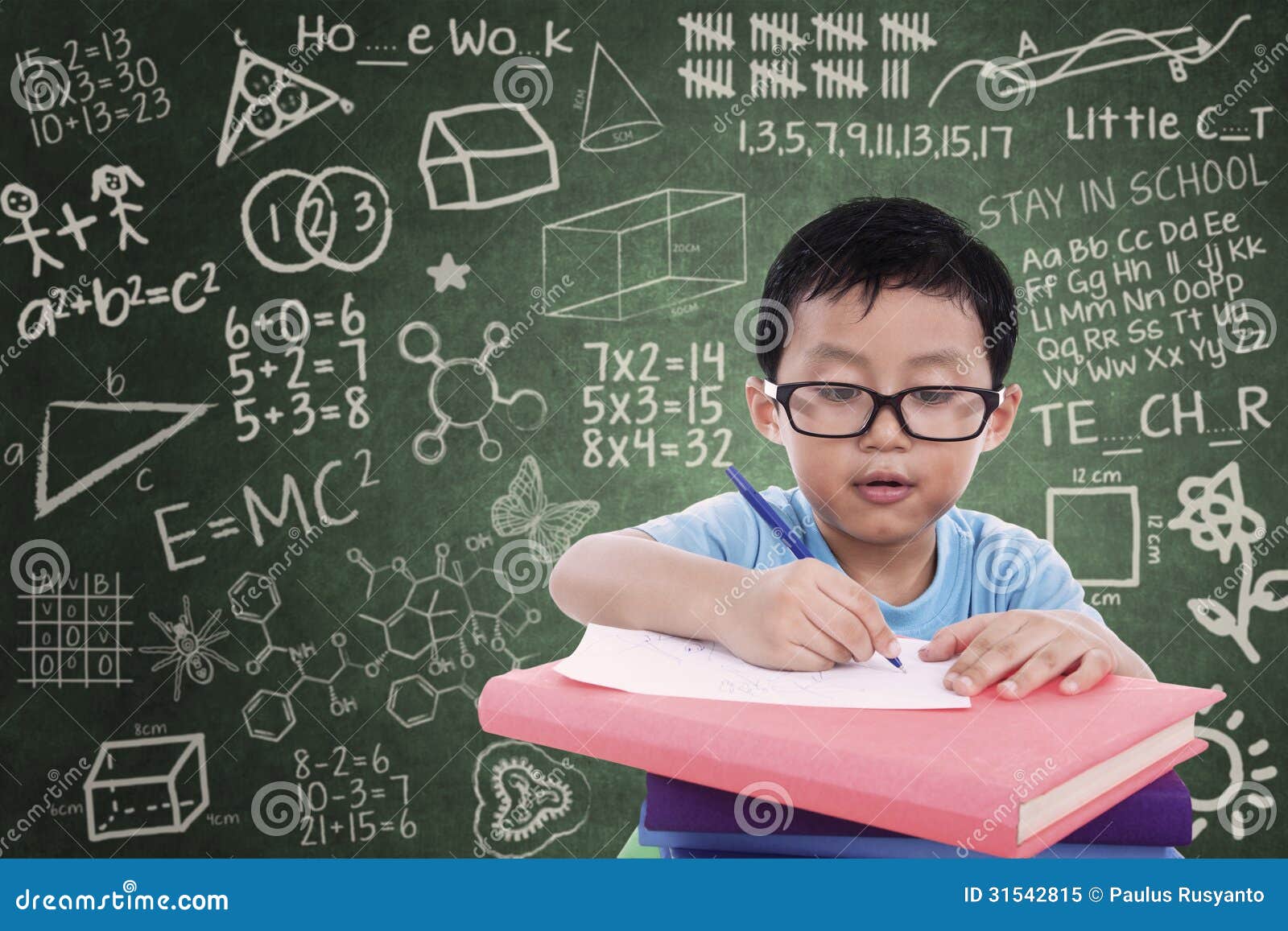 Boy Writing on Book in Classroom Stock Image - Image of intelligent ...