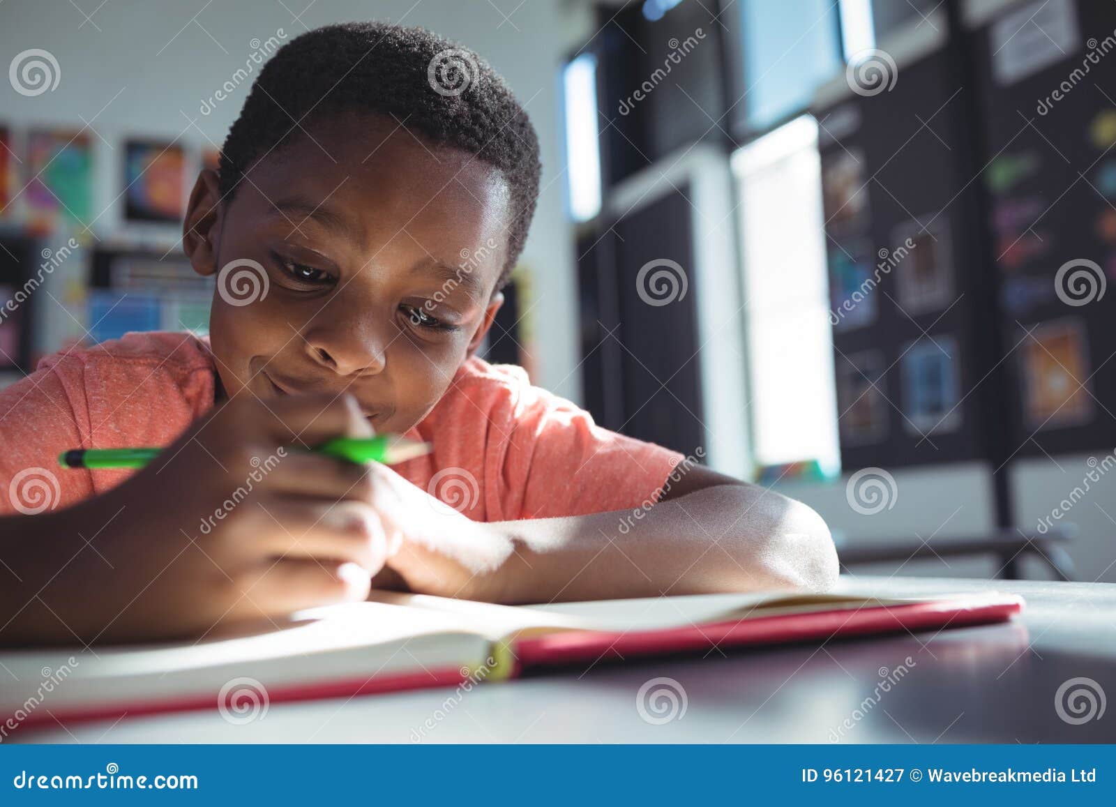 Boy writing in book stock image. Image of child, light - 96121427