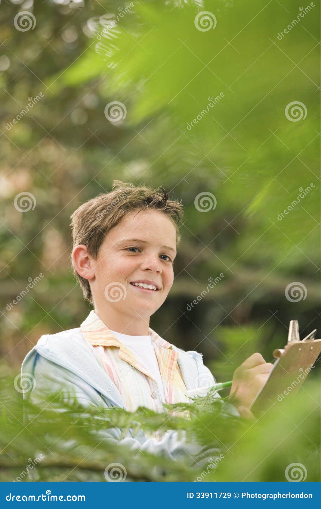 Boy Writing on Clipboard in Forest Stock Image - Image of green ...
