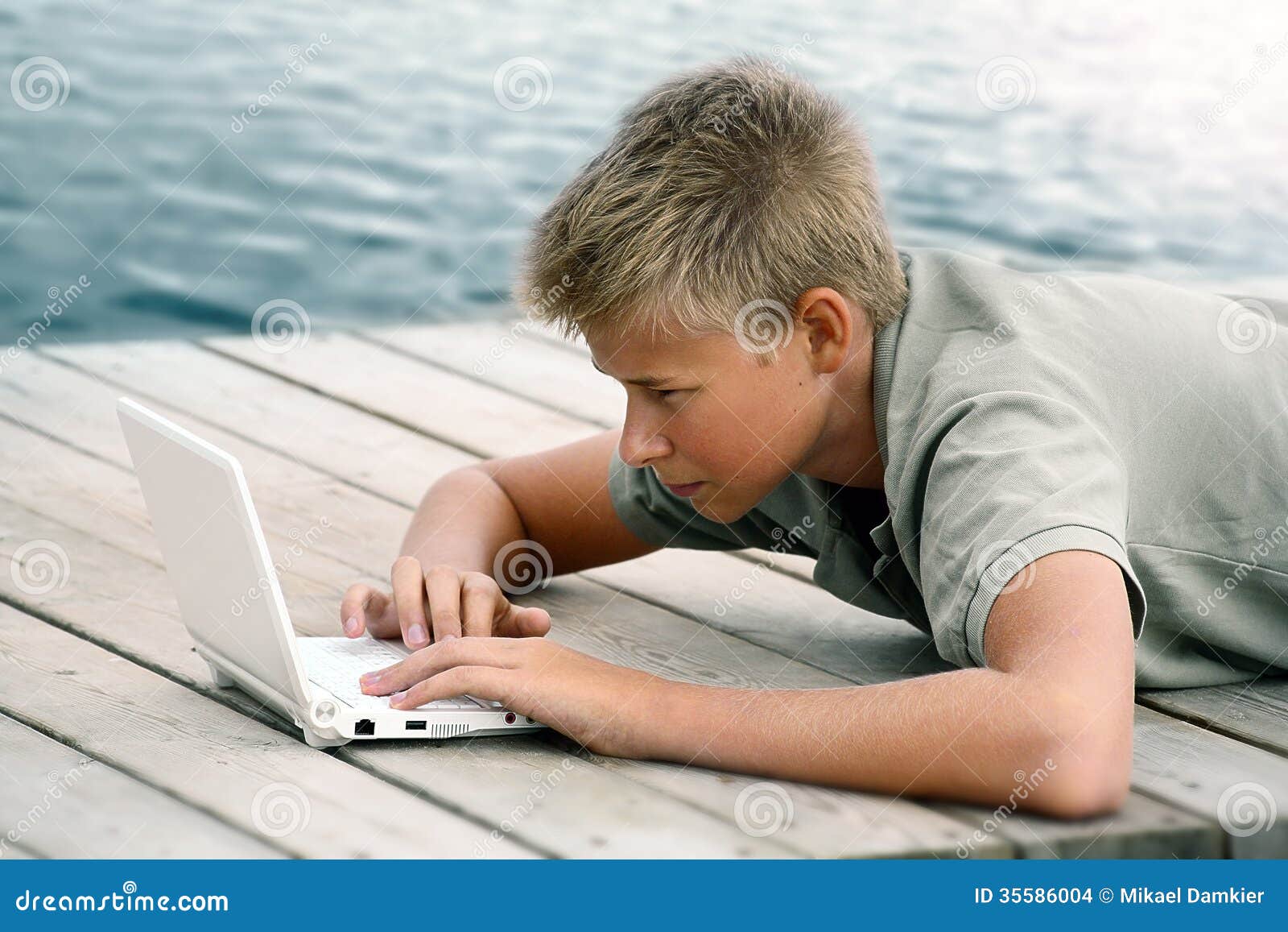Boy writing with computer stock photo. Image of outdoors - 35586004