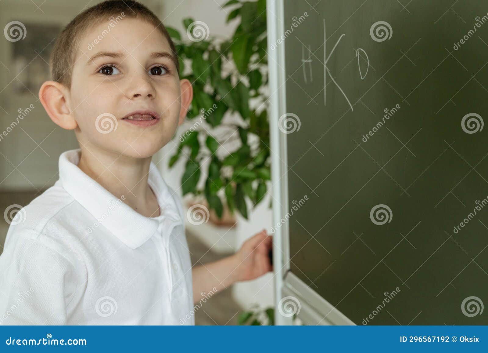 Boy Writing His Name on the Green Chalkboard Stock Photo - Image of ...