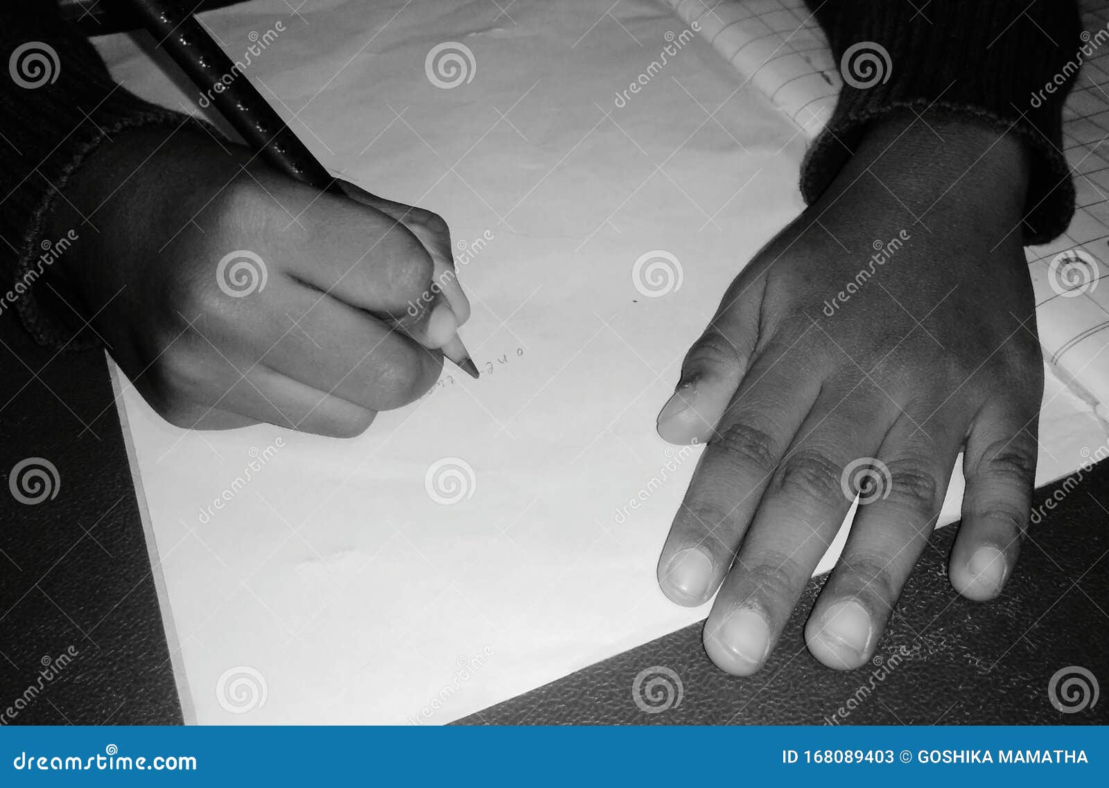 A boy writing on the paper stock image. Image of student - 168089403