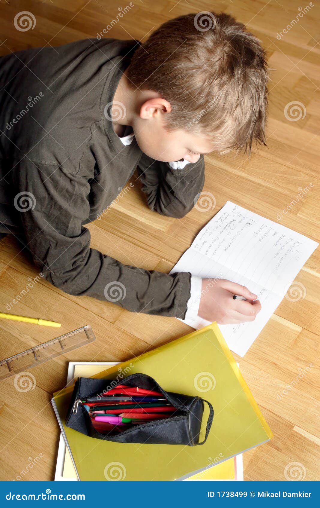 Boy Writing on Paper, Lying on the Ground Stock Image - Image of ...