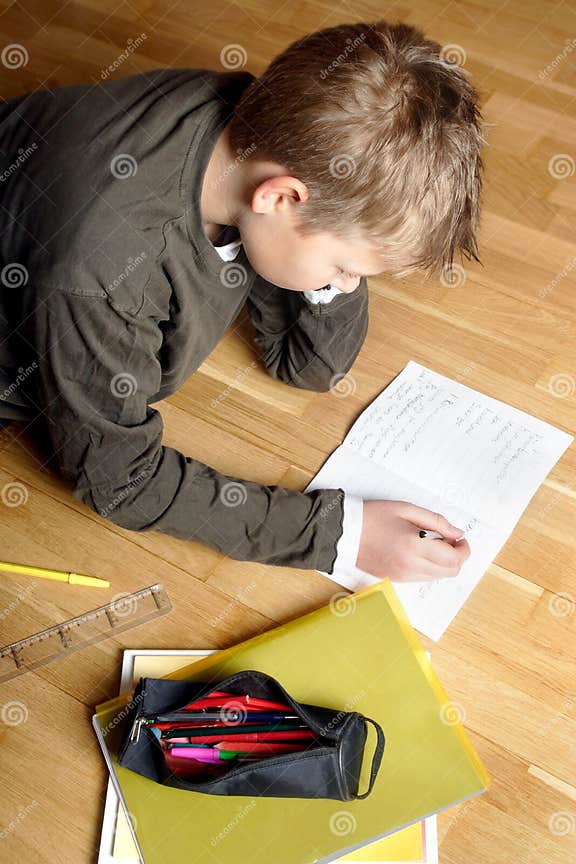 Boy Writing on Paper, Lying on the Ground Stock Image - Image of ...