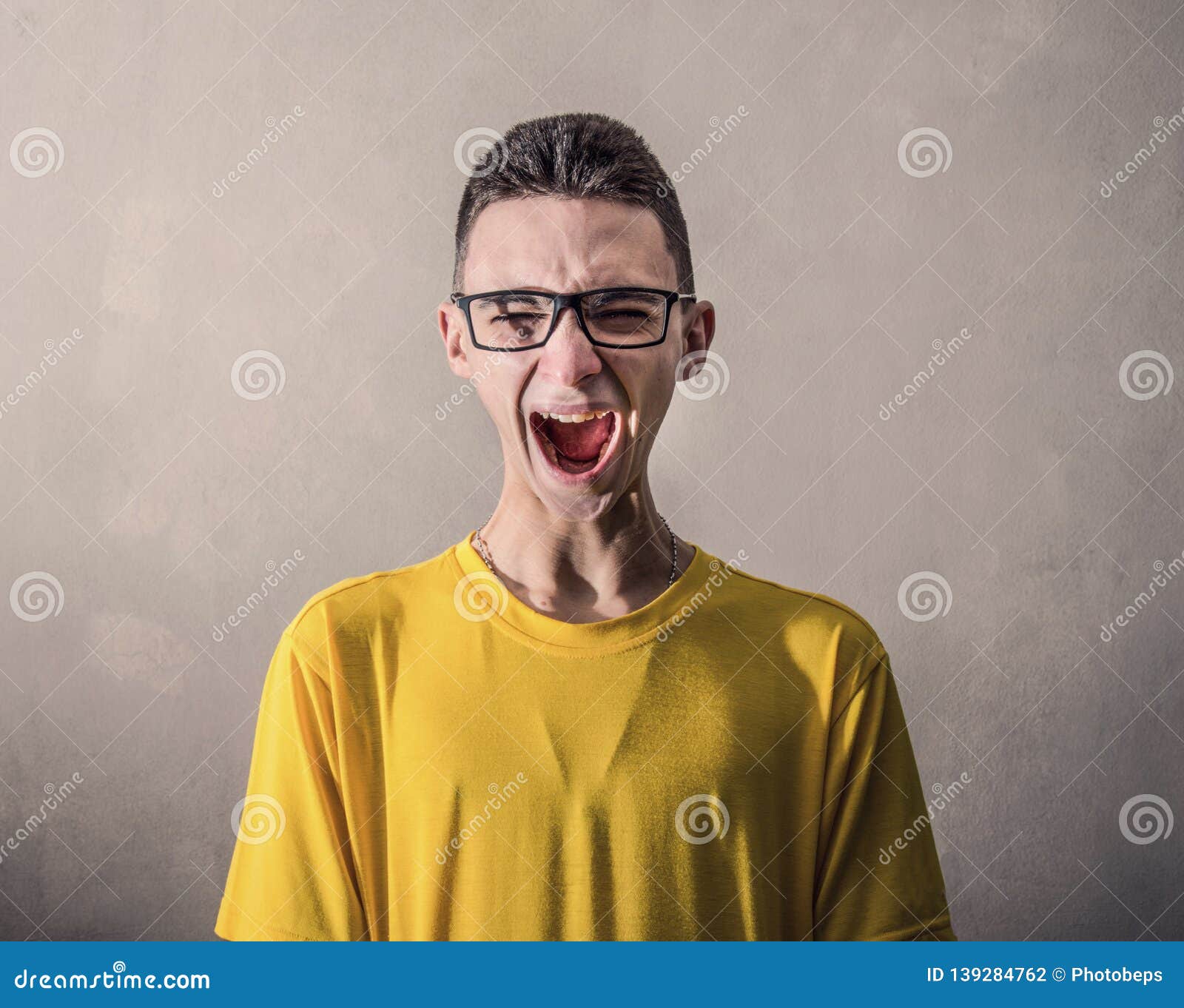 Boy with Yellow T-shirt Screaming Stock Photo - Image of face, mouth ...