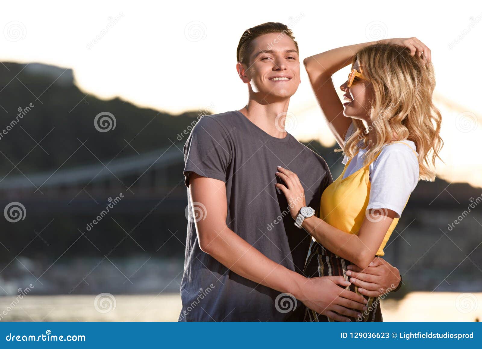 Boyfriend Hugging Girlfriend on River Beach in Evening and Looking ...