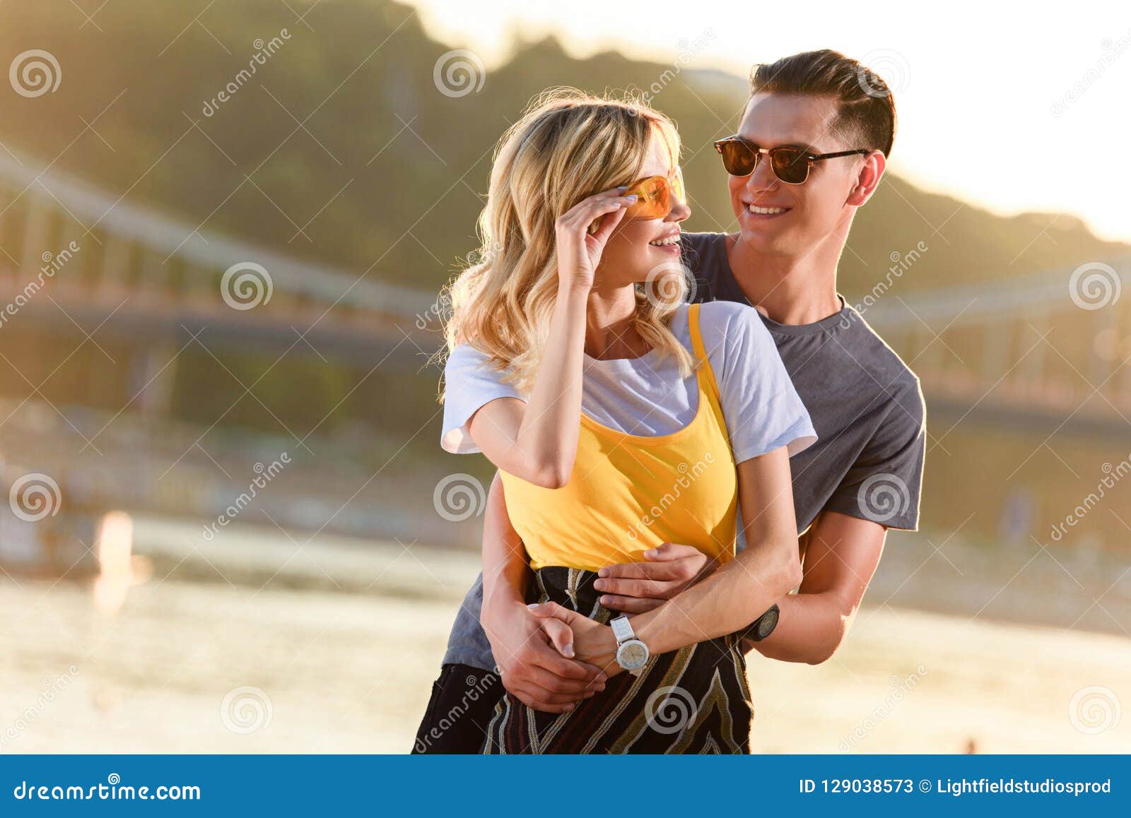 Boyfriend Hugging Girlfriend on River Beach during Sunset she Stock ...