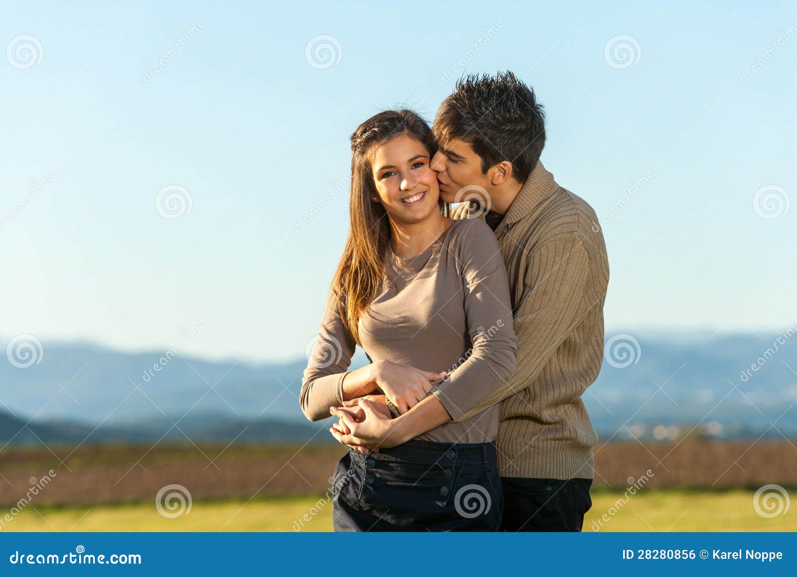 Boyfriend Kissing Girlfriend on Cheek Outdoors. Stock Photo - Image of ...