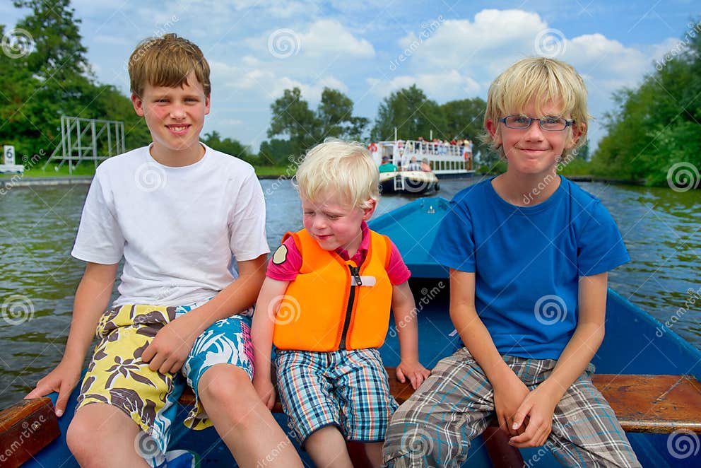 Boys in the boat stock photo. Image of lake, blue, three - 20735070
