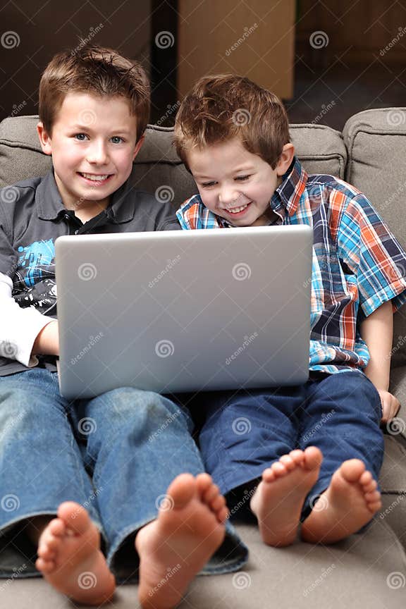 Boys with computer stock image. Image of couch, indoor - 18483861