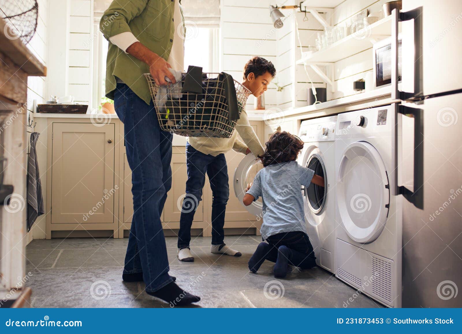 Boys Doing Laundry with Father Holding Basket Stock Image - Image of ...