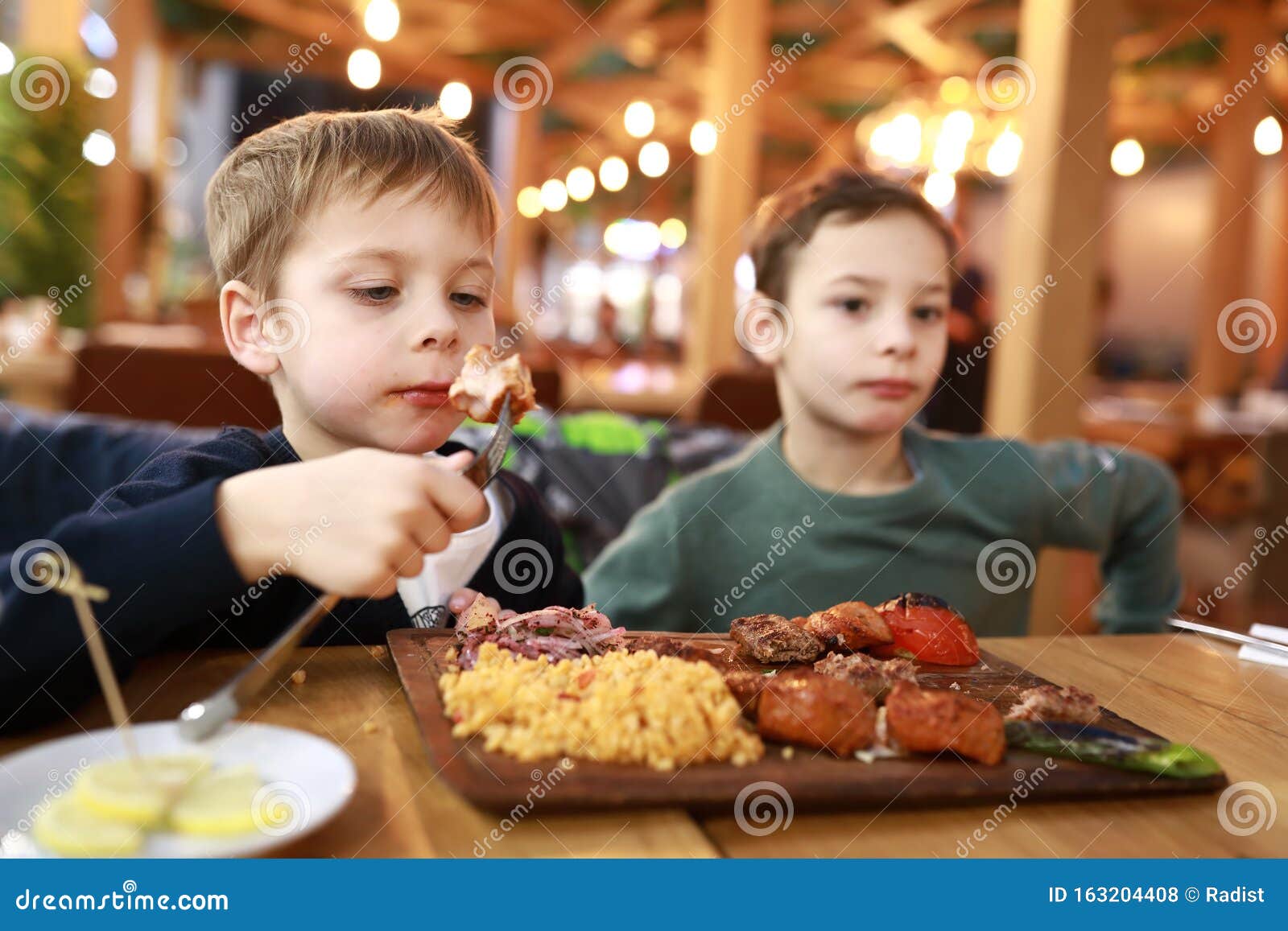 Boys eating kebabs stock photo. Image of lunch, hungry - 163204408