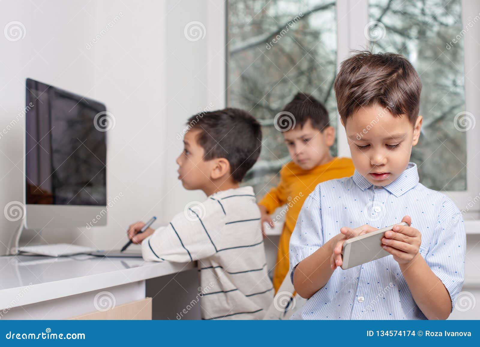 Boys Enthusiastically Draw on a Computer Using a Tablet. the Younger ...