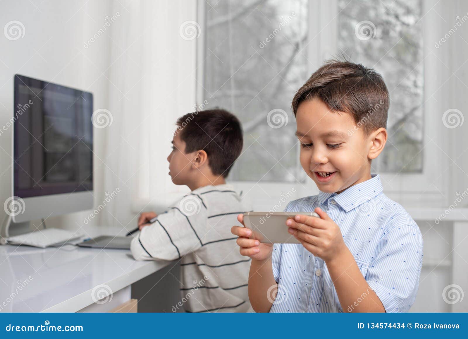 Boys Enthusiastically Draw on a Computer Using a Tablet. the Younger ...