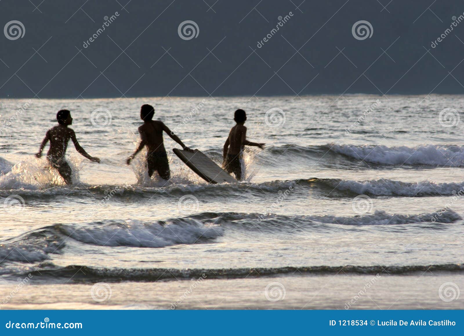 Boys Having Fun Surfing at Sunset Stock Photo - Image of boys, kids ...