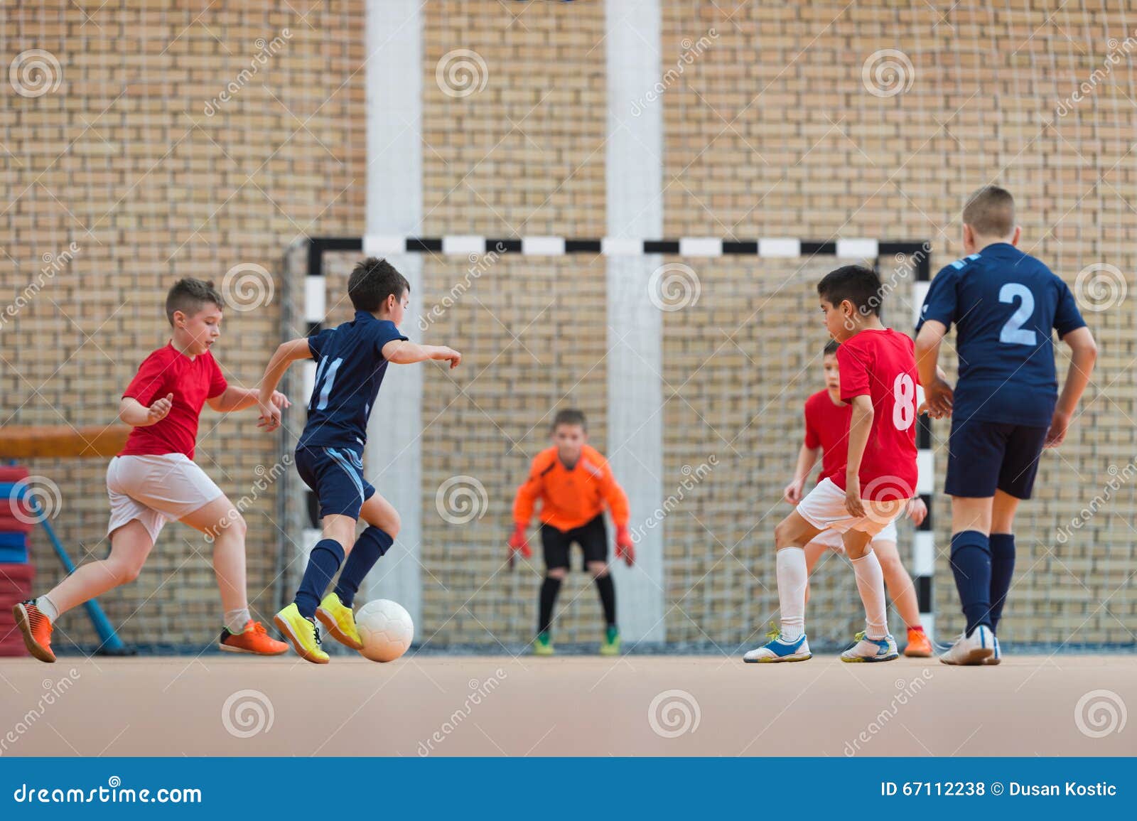Boys kicking ball stock photo. Image of goalkeeper, league - 67112238
