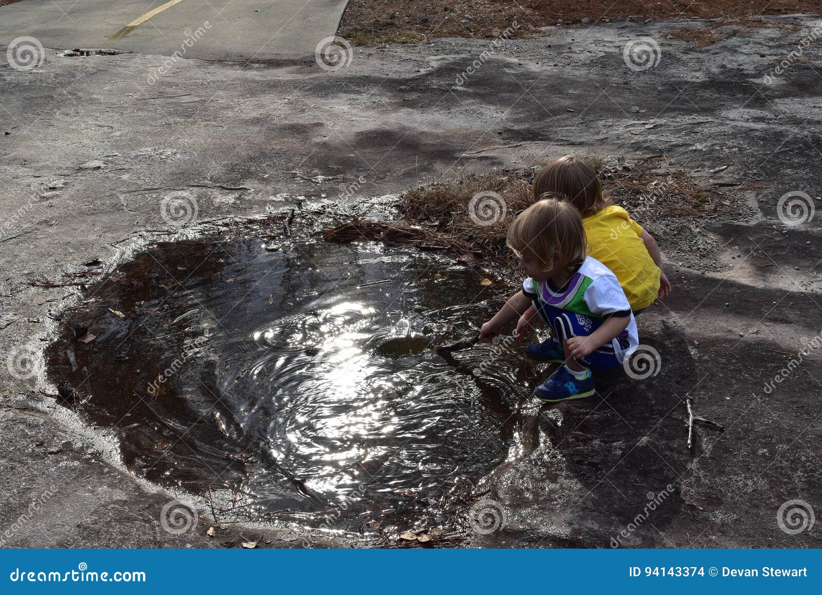 Boys playing in a puddle. editorial stock image. Image of explore ...