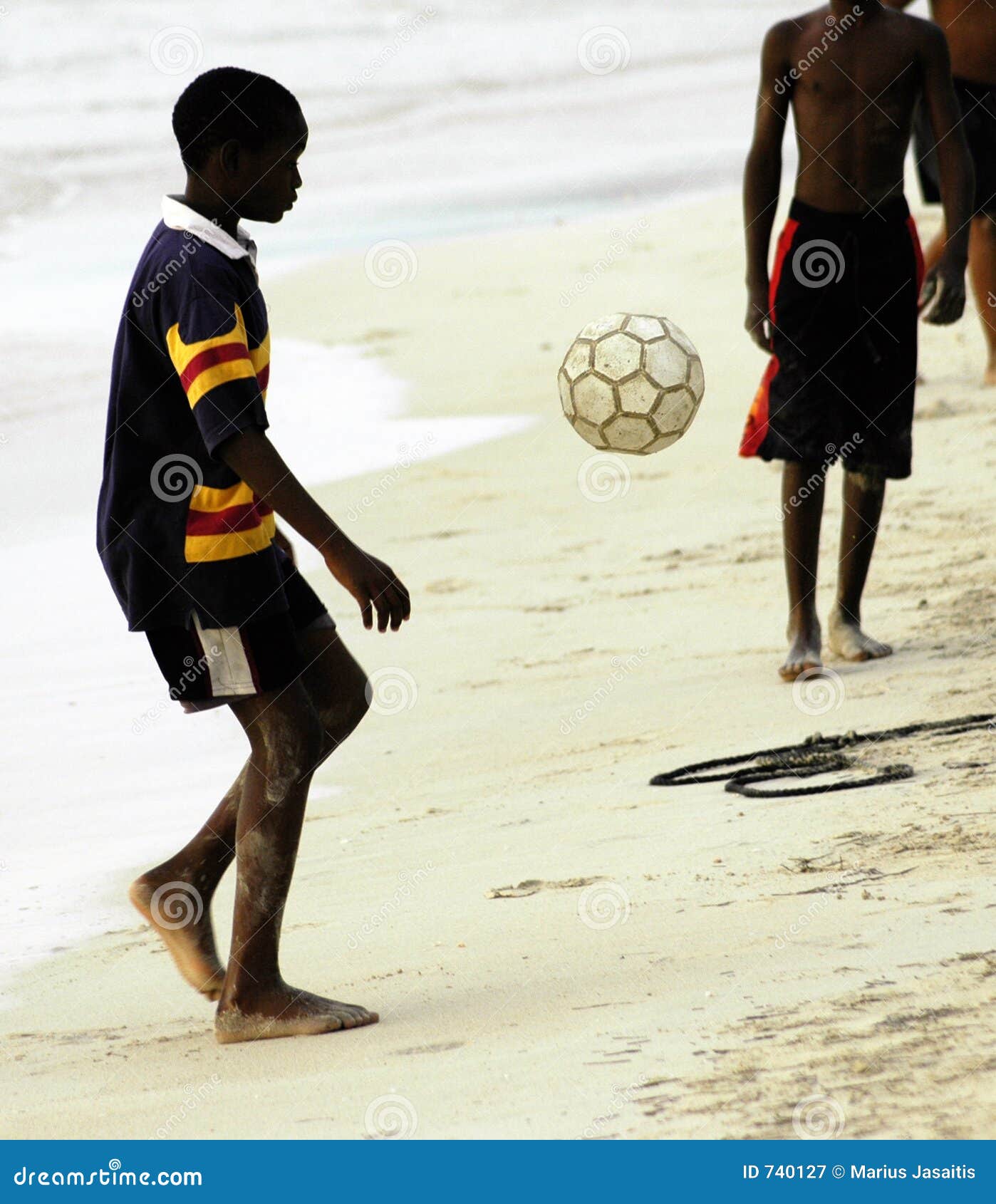 Boys playing socker stock image. Image of boys, teens, beach - 740127