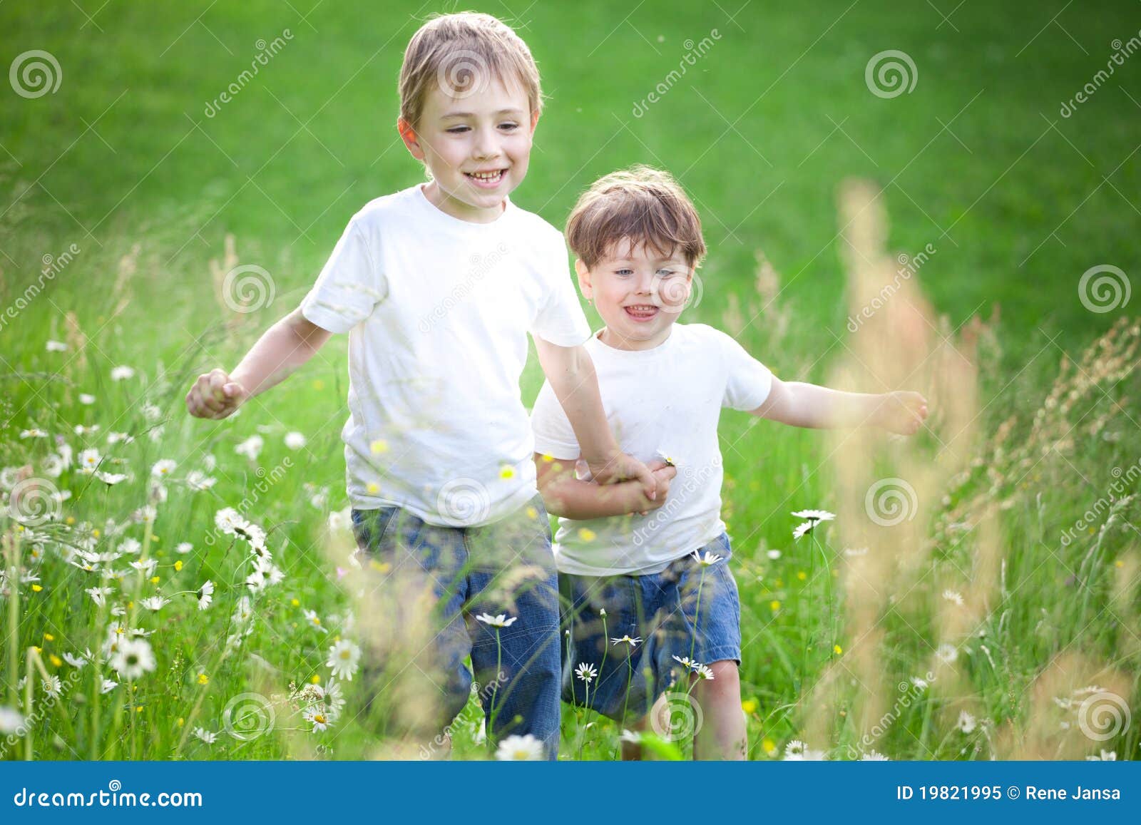 Boys running through field stock image. Image of meadow - 19821995