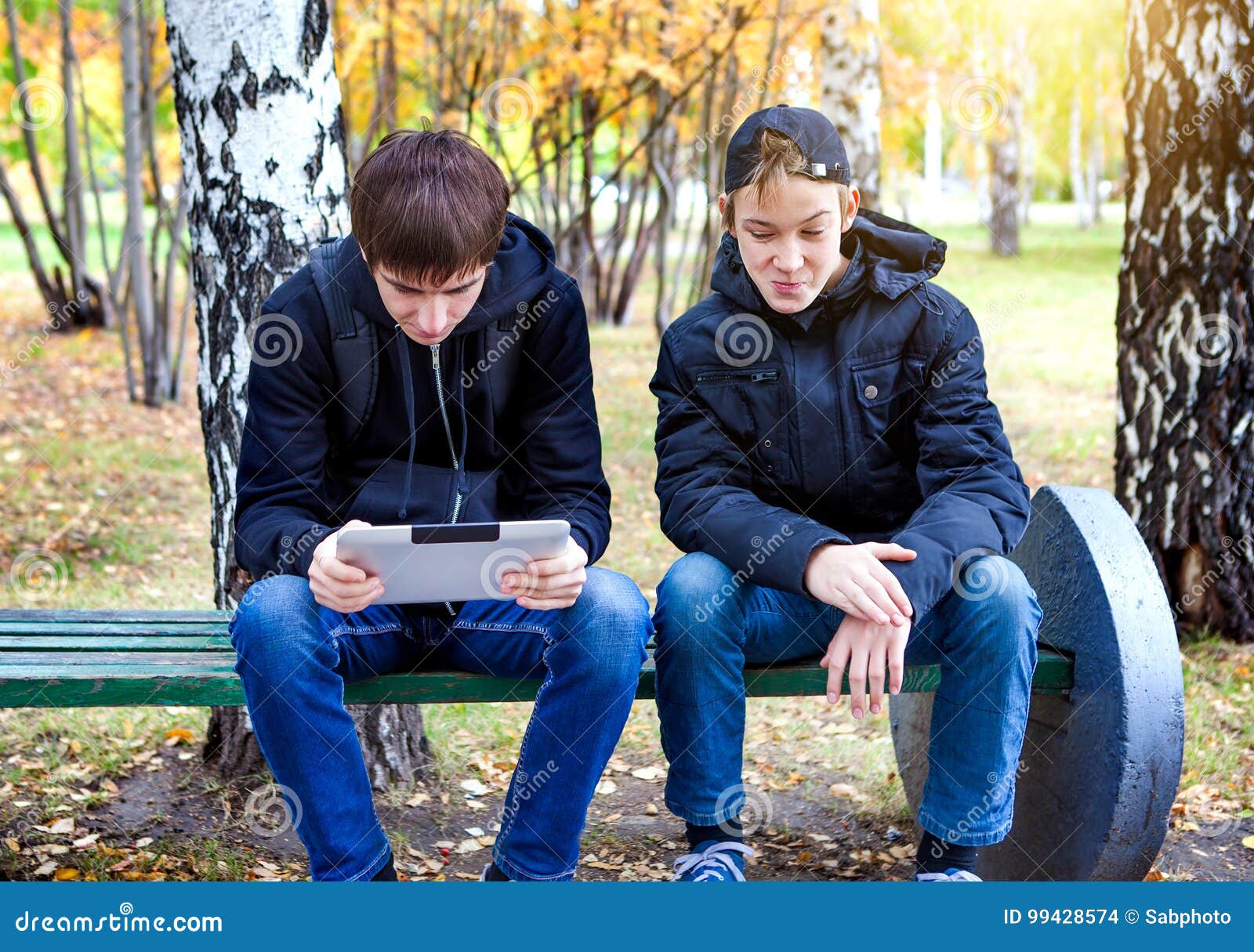Boys with a Tablet outdoor stock photo. Image of interest - 99428574