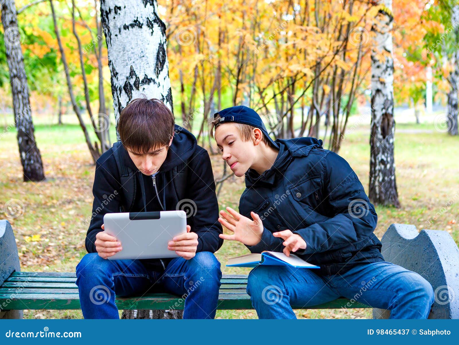 Boys with Tablet outdoor stock image. Image of bench - 98465437