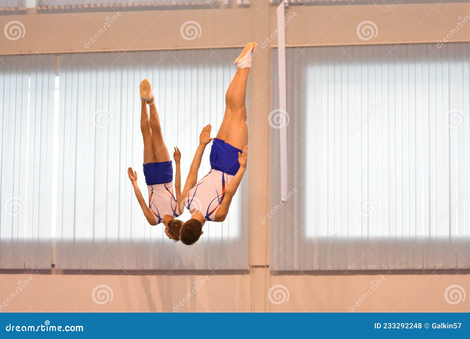 Boys Train in Synchronized Jumping on a Trampoline Stock Photo - Image ...