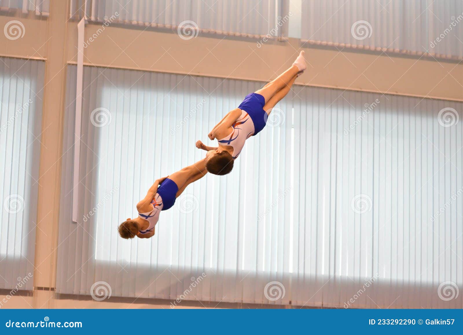 Boys Train in Synchronized Jumping on a Trampoline Stock Photo - Image ...