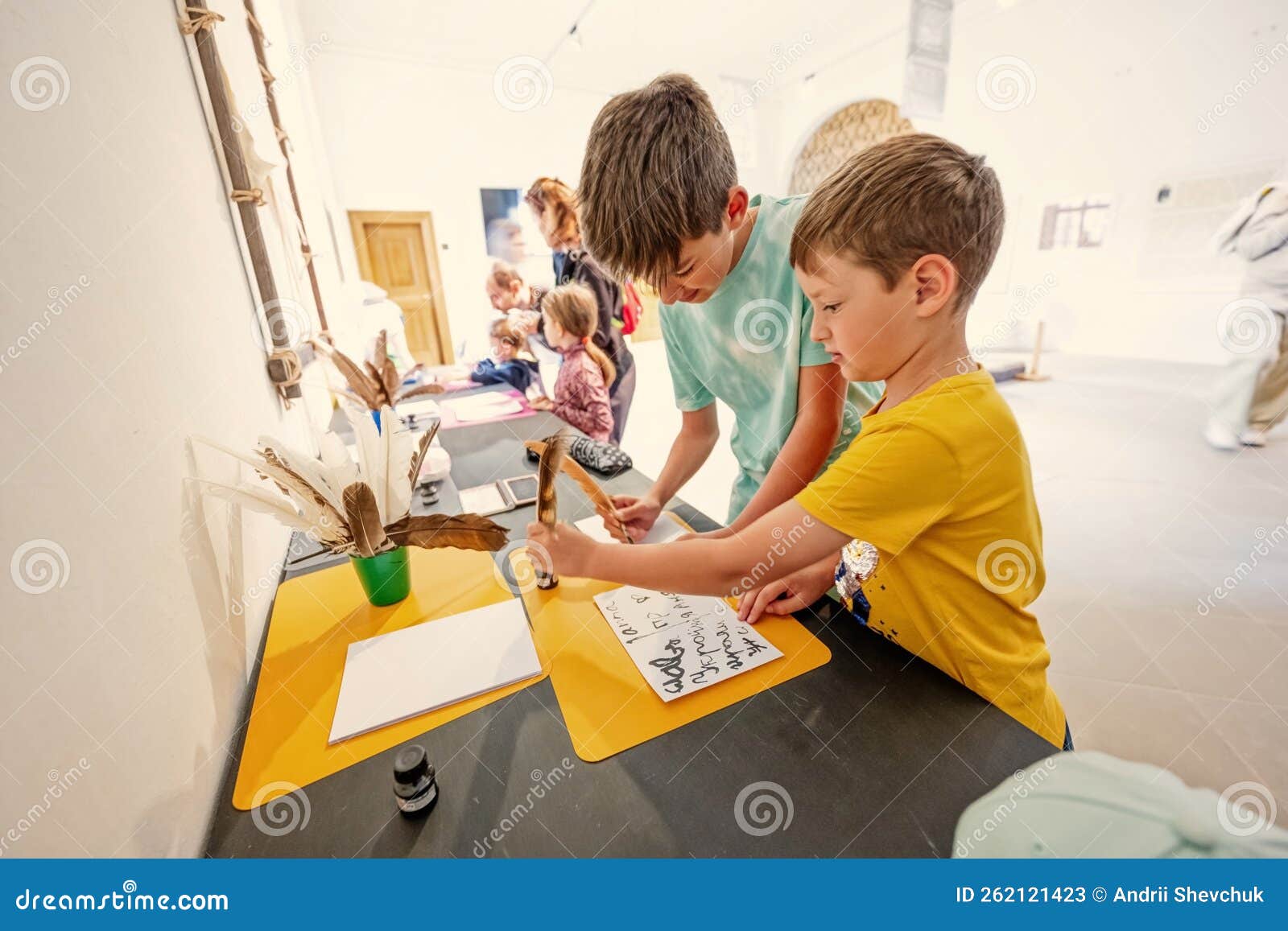 Boys Writing with Feather Quill Pen at Desk Stock Image - Image of ...
